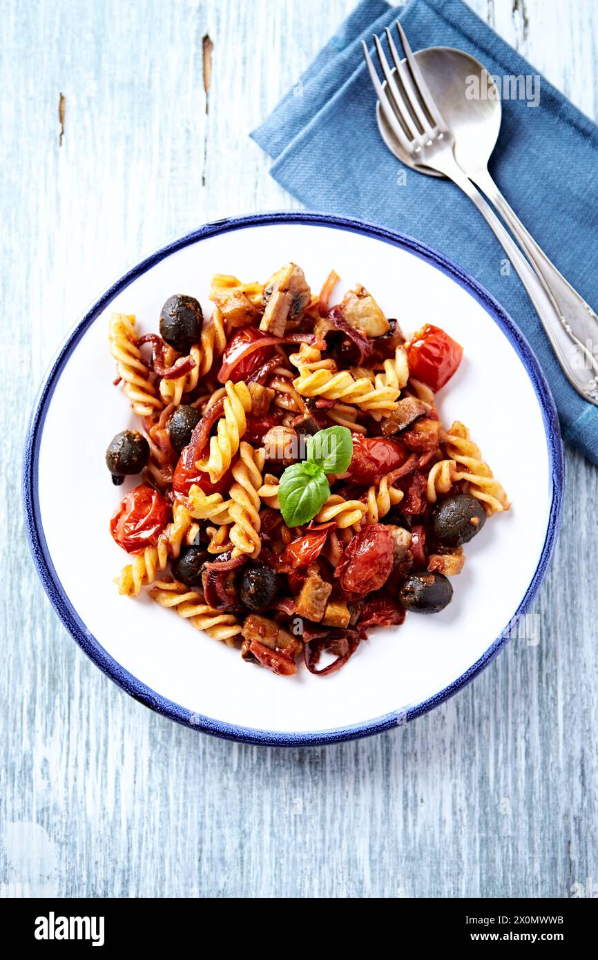 Penne pasta with yellow and red pepper, hard cheese and fresh basil ...