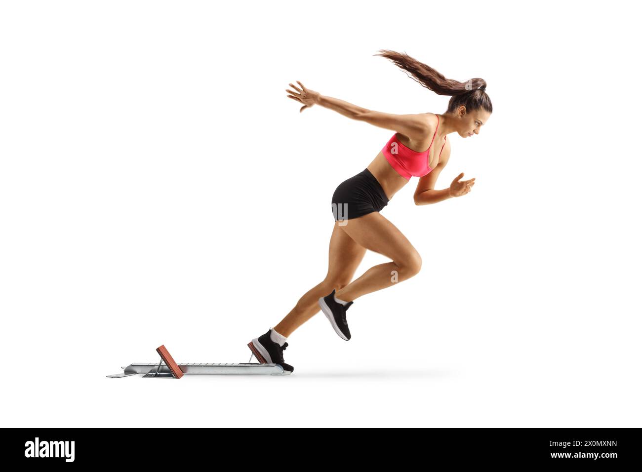 Female runner starting a race from a starting block isolated on white ...