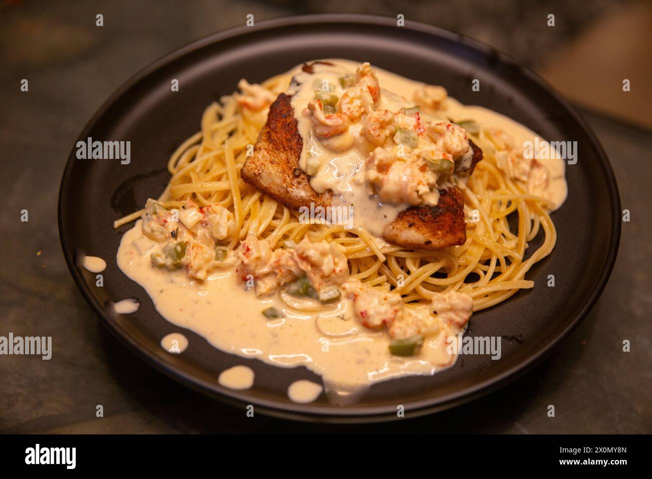 Blackened Snapper with Crawfish Pasta plated Stock Photo - Alamy