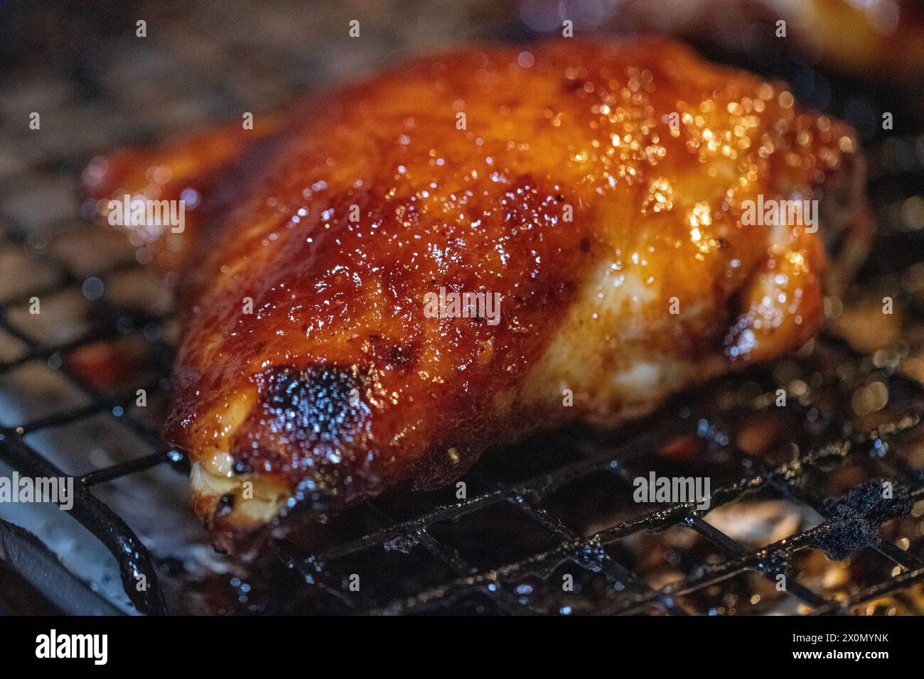 Baked BBQ Chicken Thigh topped with sauce Stock Photo - Alamy