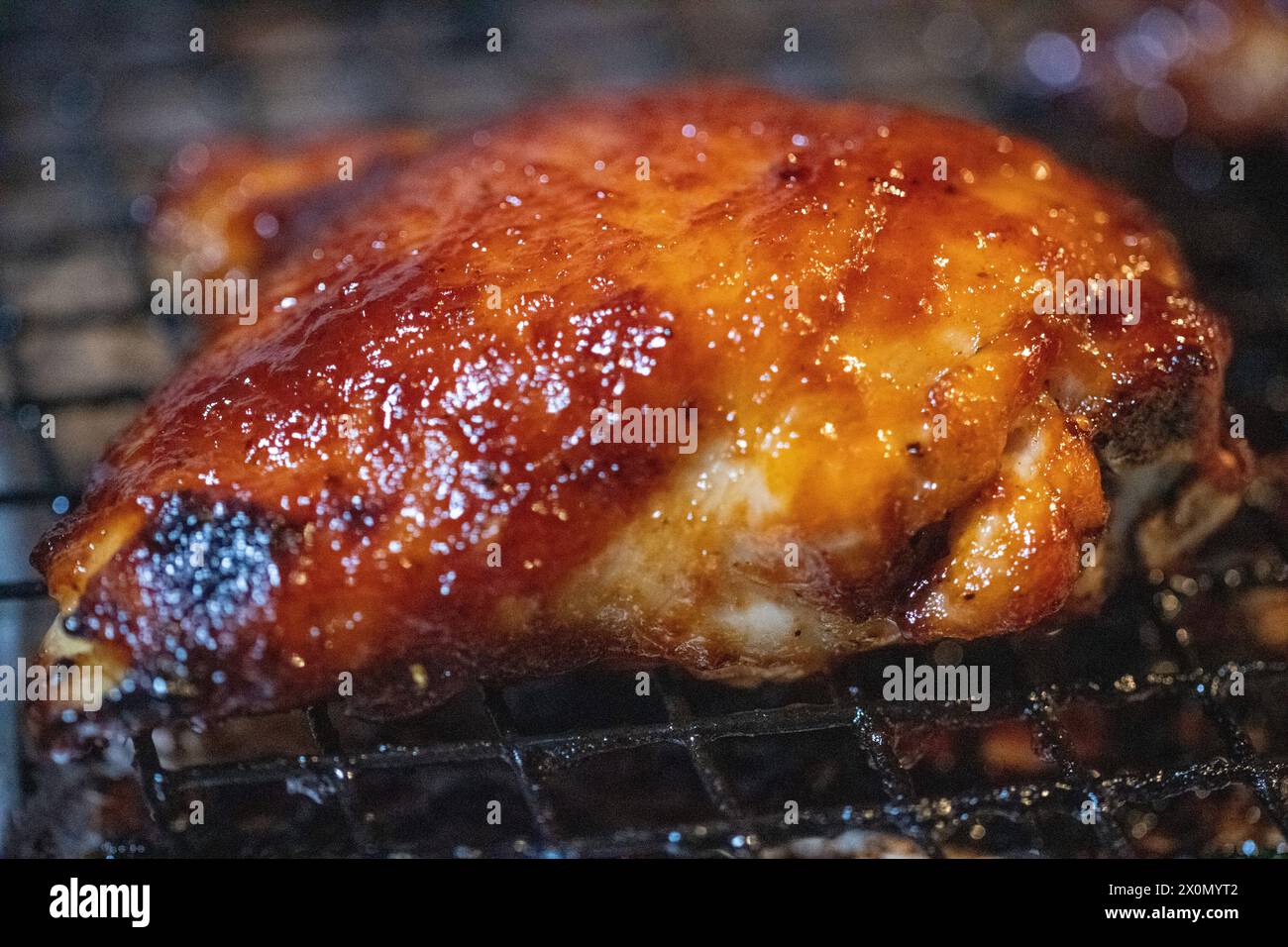Baked BBQ Chicken Thigh topped with sauce Stock Photo - Alamy