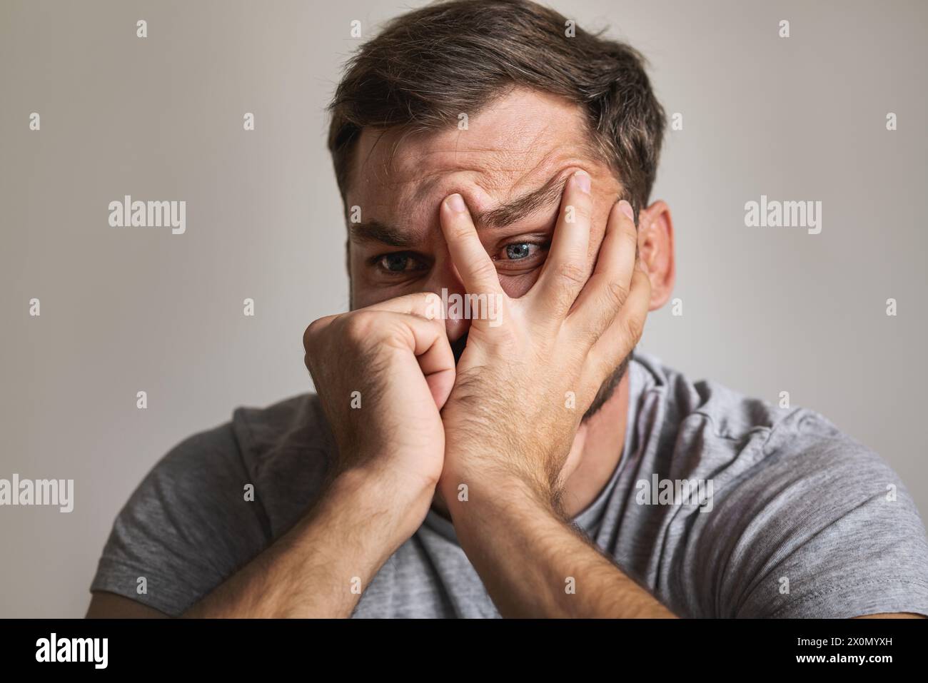 Male mental illness concept. Close-up of a man's face with an ...