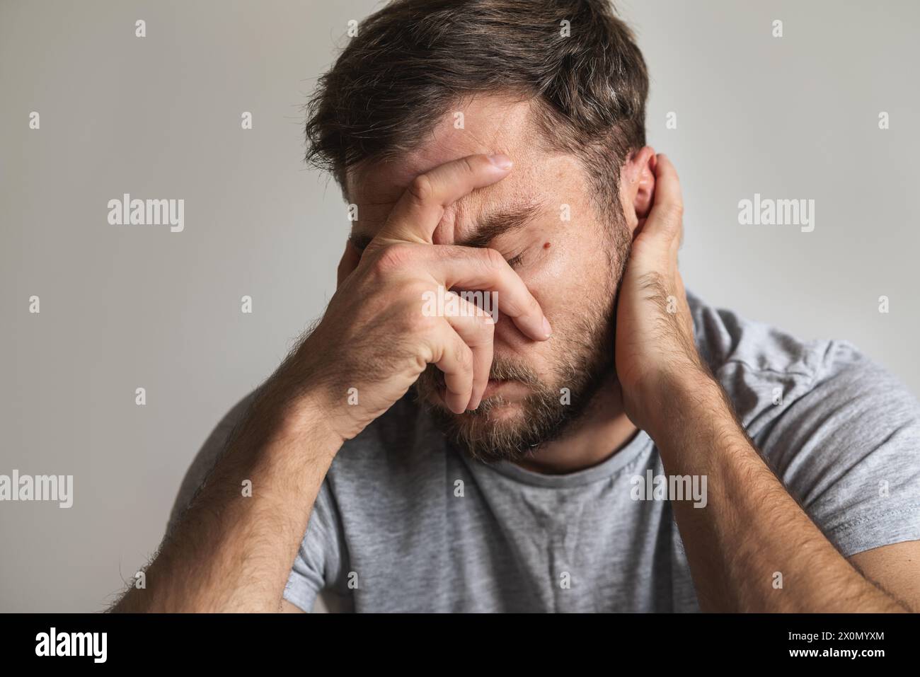 Grief and mental illness expression. Unhappy man with covered face with ...