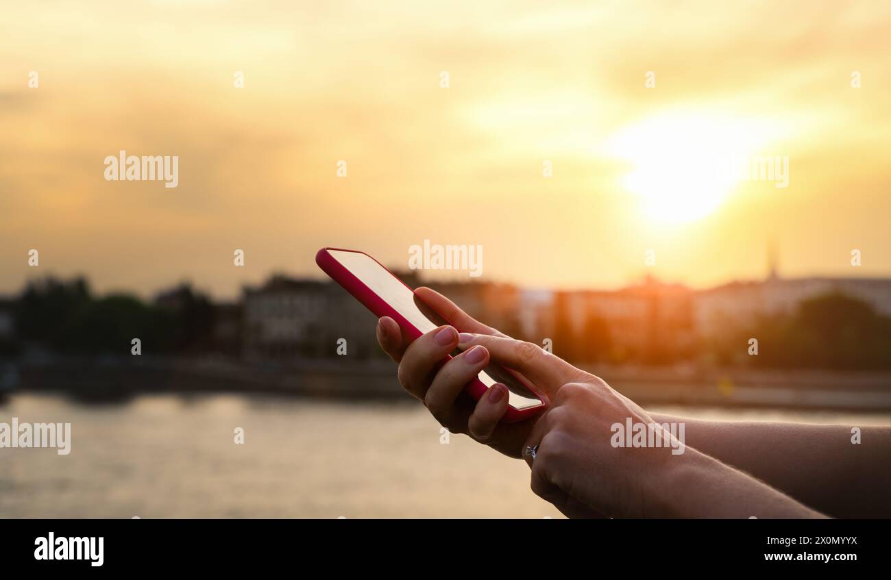 Female person touching screen of her phone with her finger in front of ...