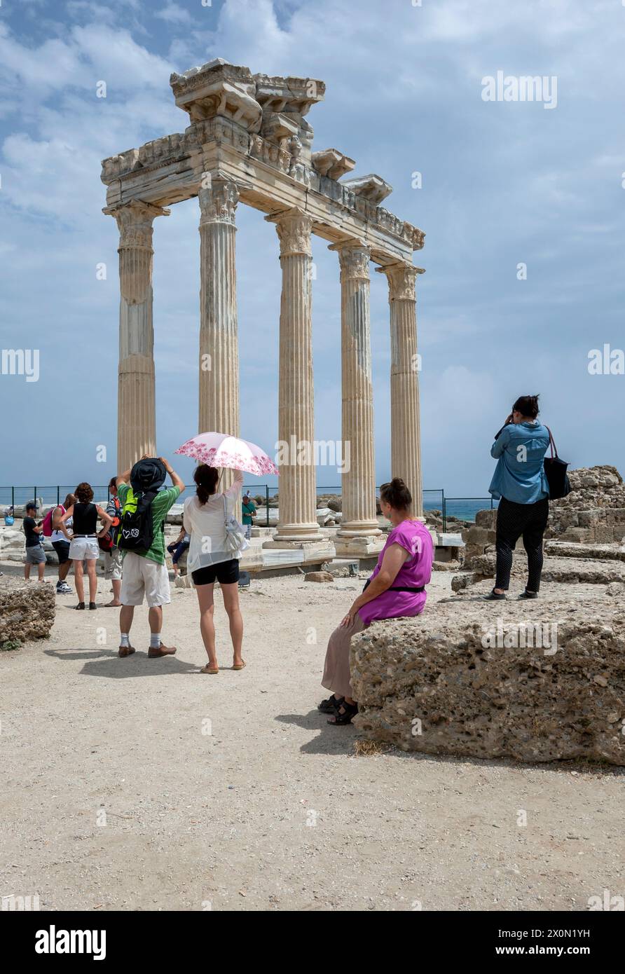 Tourists admire the ruins of the Temple of Apollo at Side in the ...