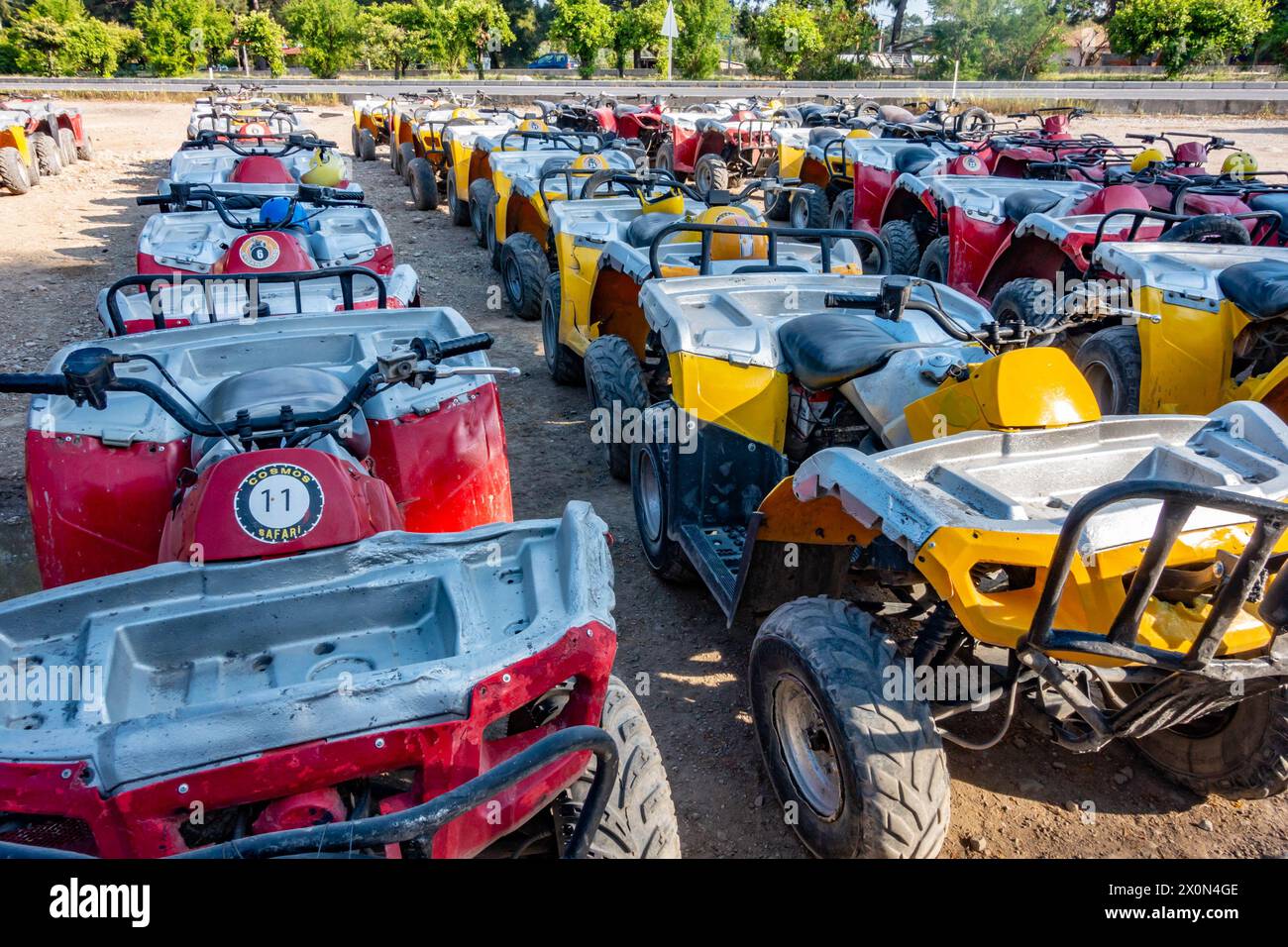Red and yellow quad bikes lined up after the end of an excursion in ...