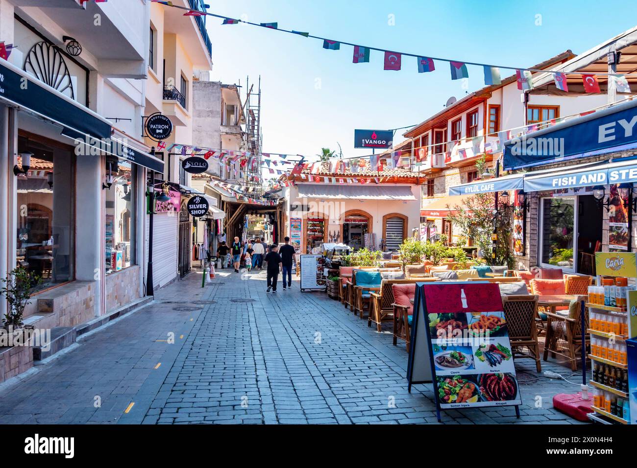 Shops and restaurants along a street in the old town of Antalya in ...