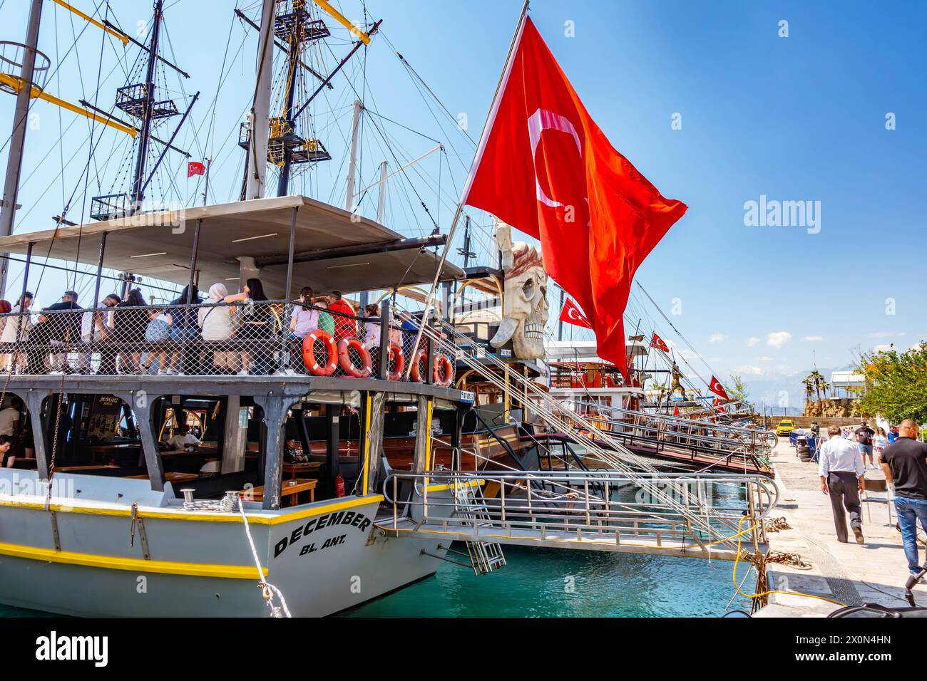 The Turkish flag flies from the back of a pleasure boat moored in ...