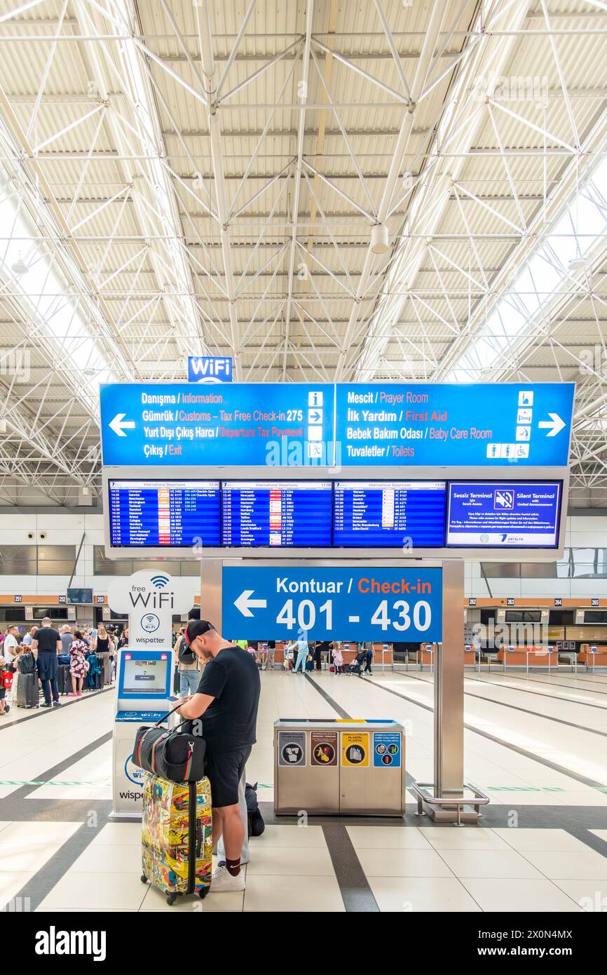 Departure boards in the check-in hall at Antalaya Airport Terminal 2 in ...
