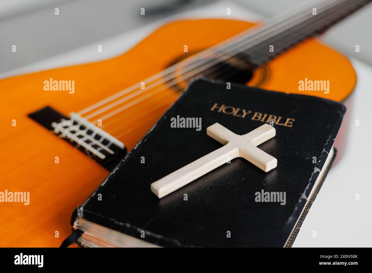 Acoustic guitar with the Holy Bible on the table close up. Worship God ...