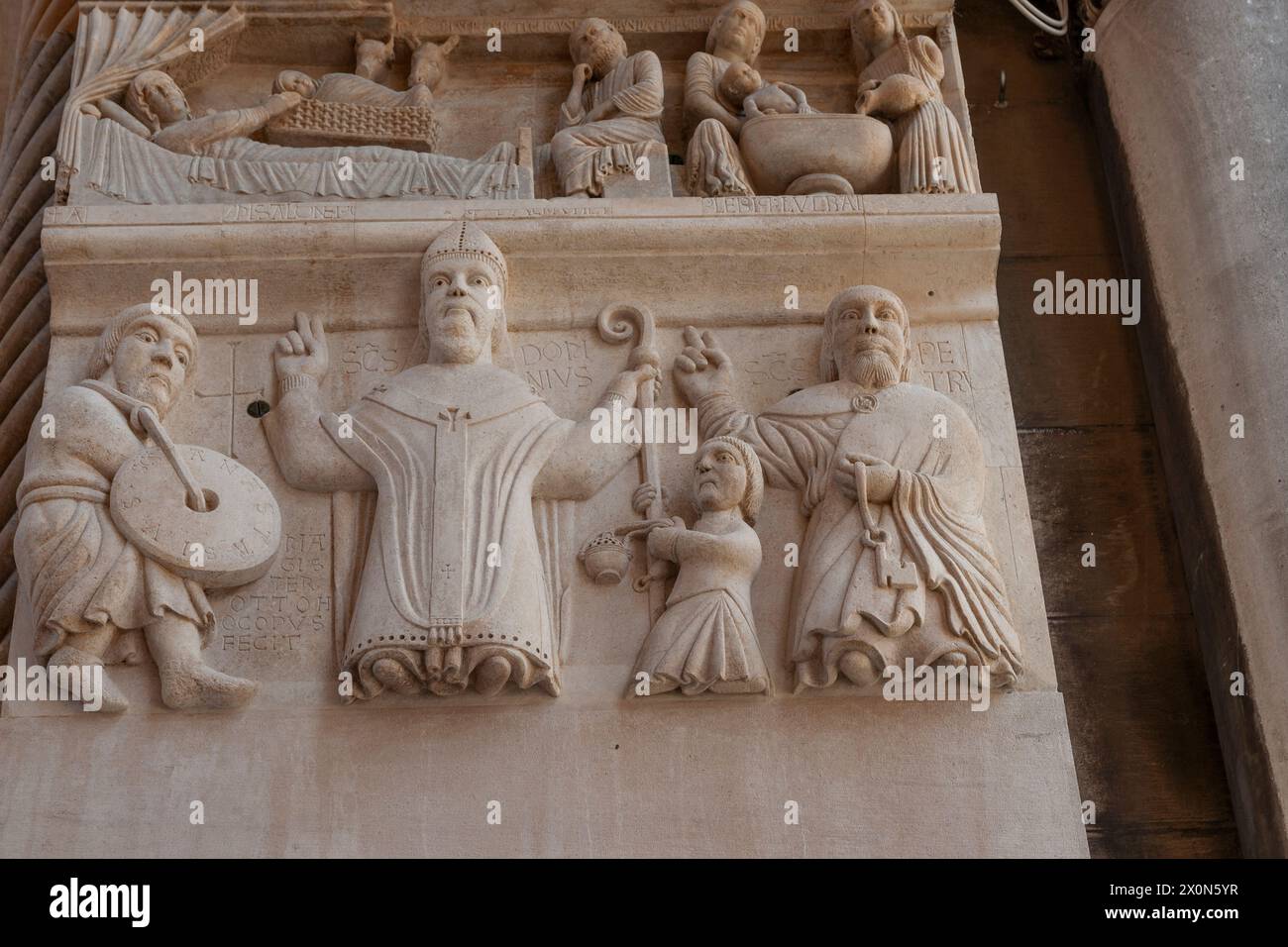 Stone plaque of religious figure one with millstone around neck at ...