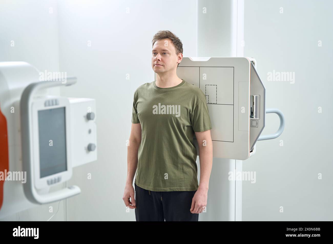 Adult man getting digital radiography of shoulder in anteroposterior ...