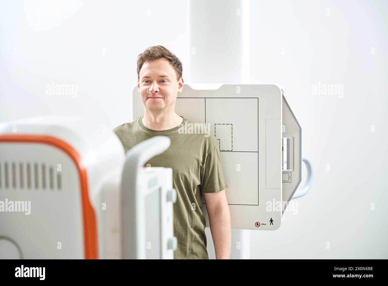 Adult patient is undergoing shoulder radiography in anteroposterior ...