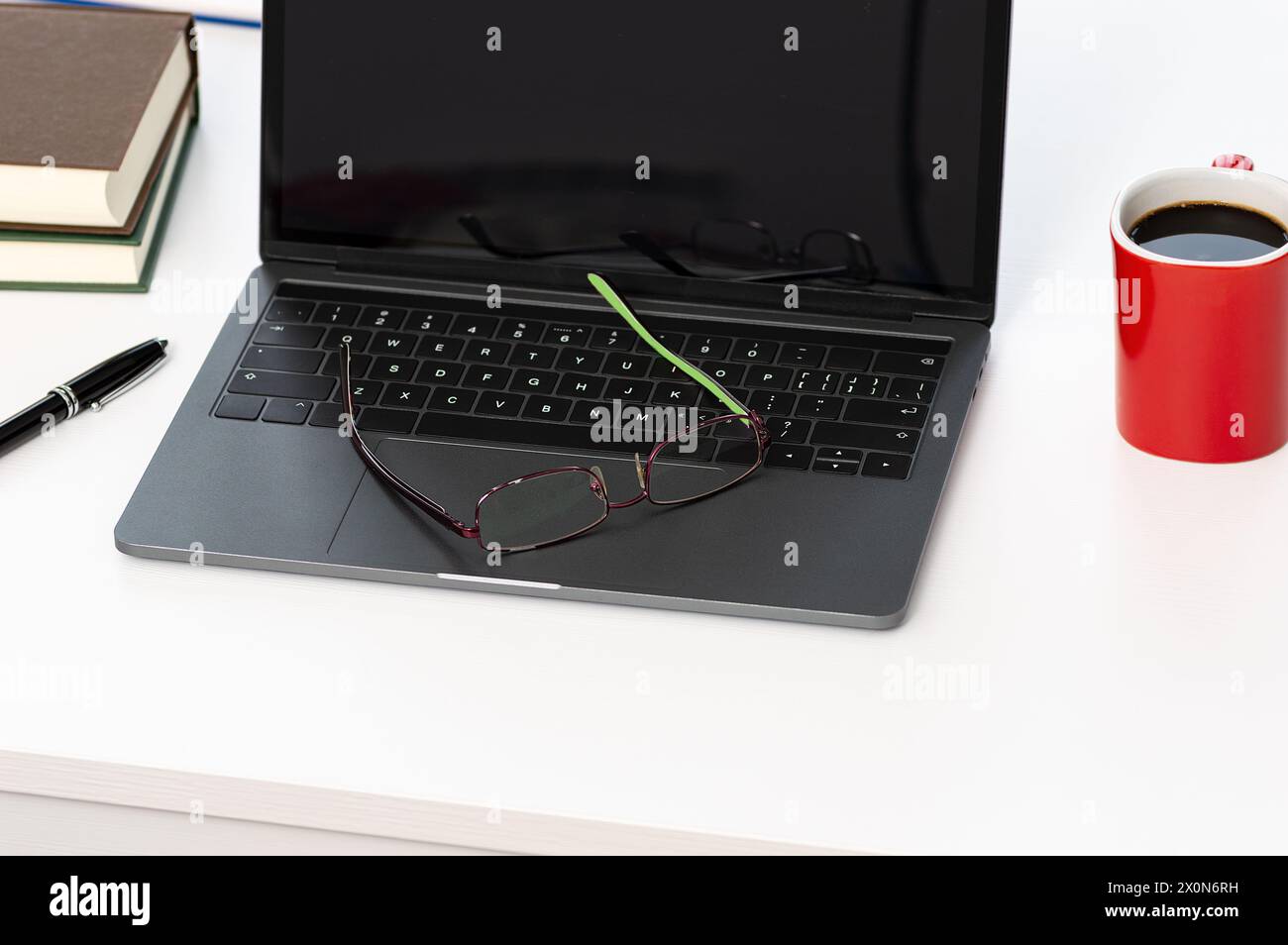 Glasses on a laptop at an office workstation Stock Photo - Alamy
