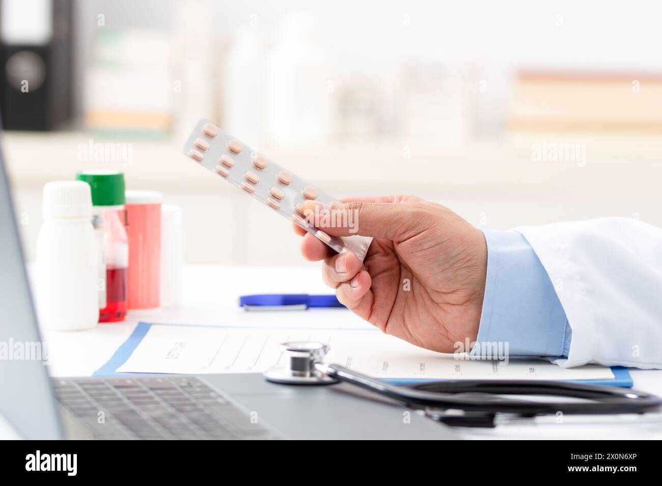 Shot of a young doctor filling out a form for a prescription in her ...