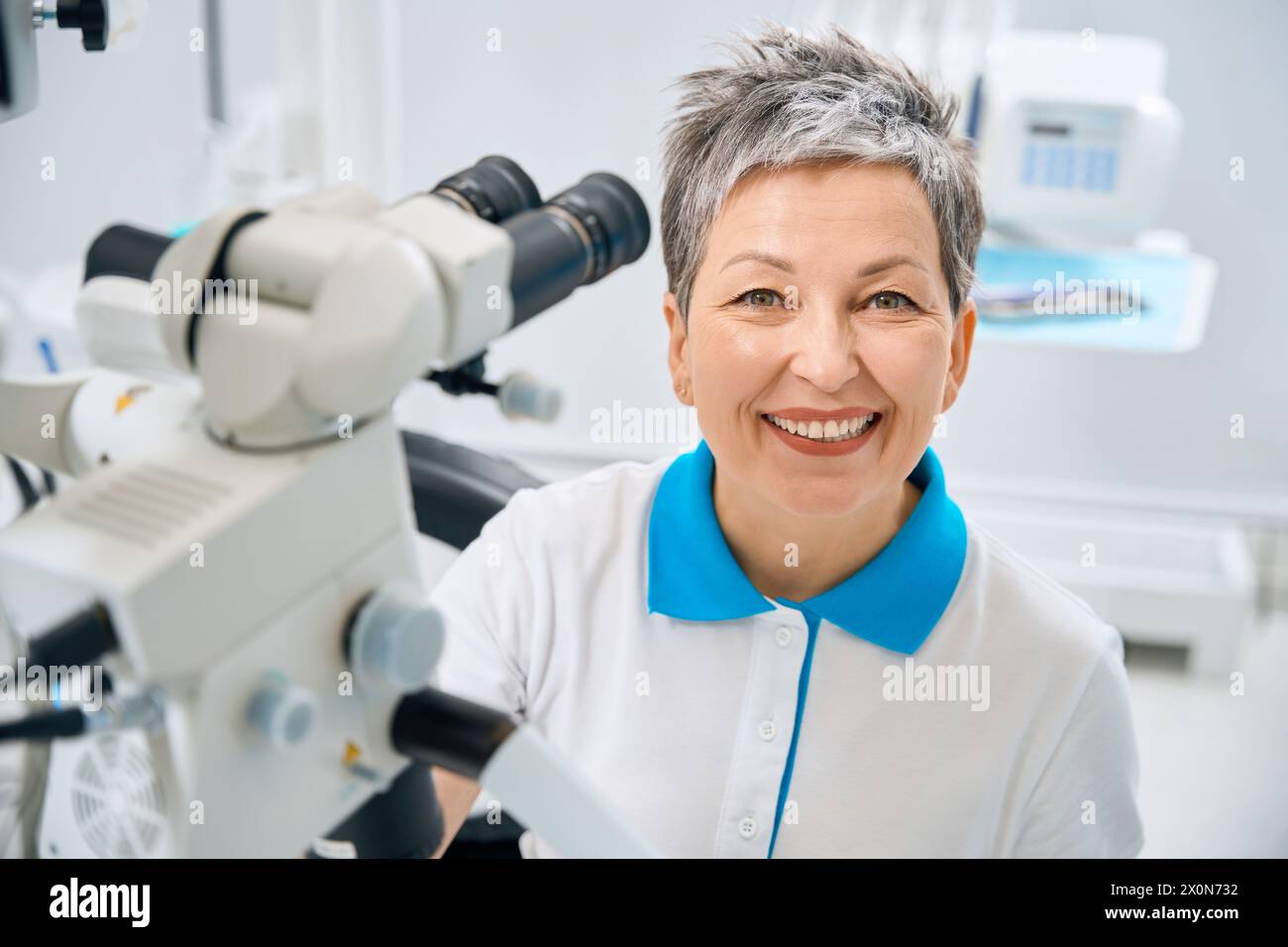 Woman aesthetic dentist spending time in her office with modern ...