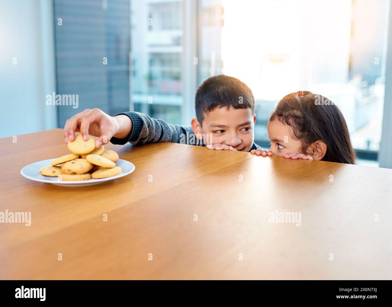 Home, brother and sister in kitchen, biscuits and siblings together ...