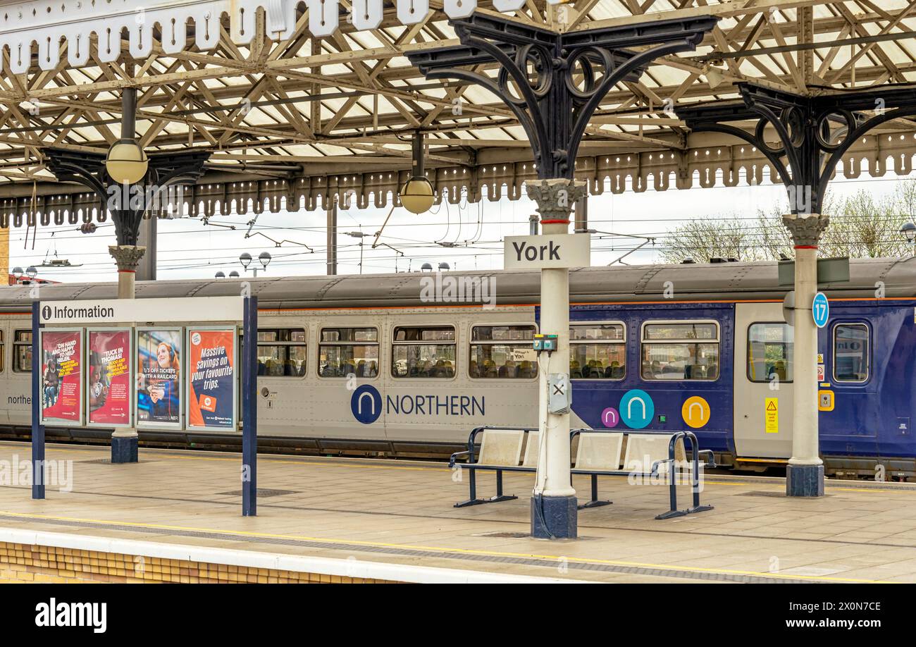 A train stands by a 19th Century historic canopy preparing to depart. A ...