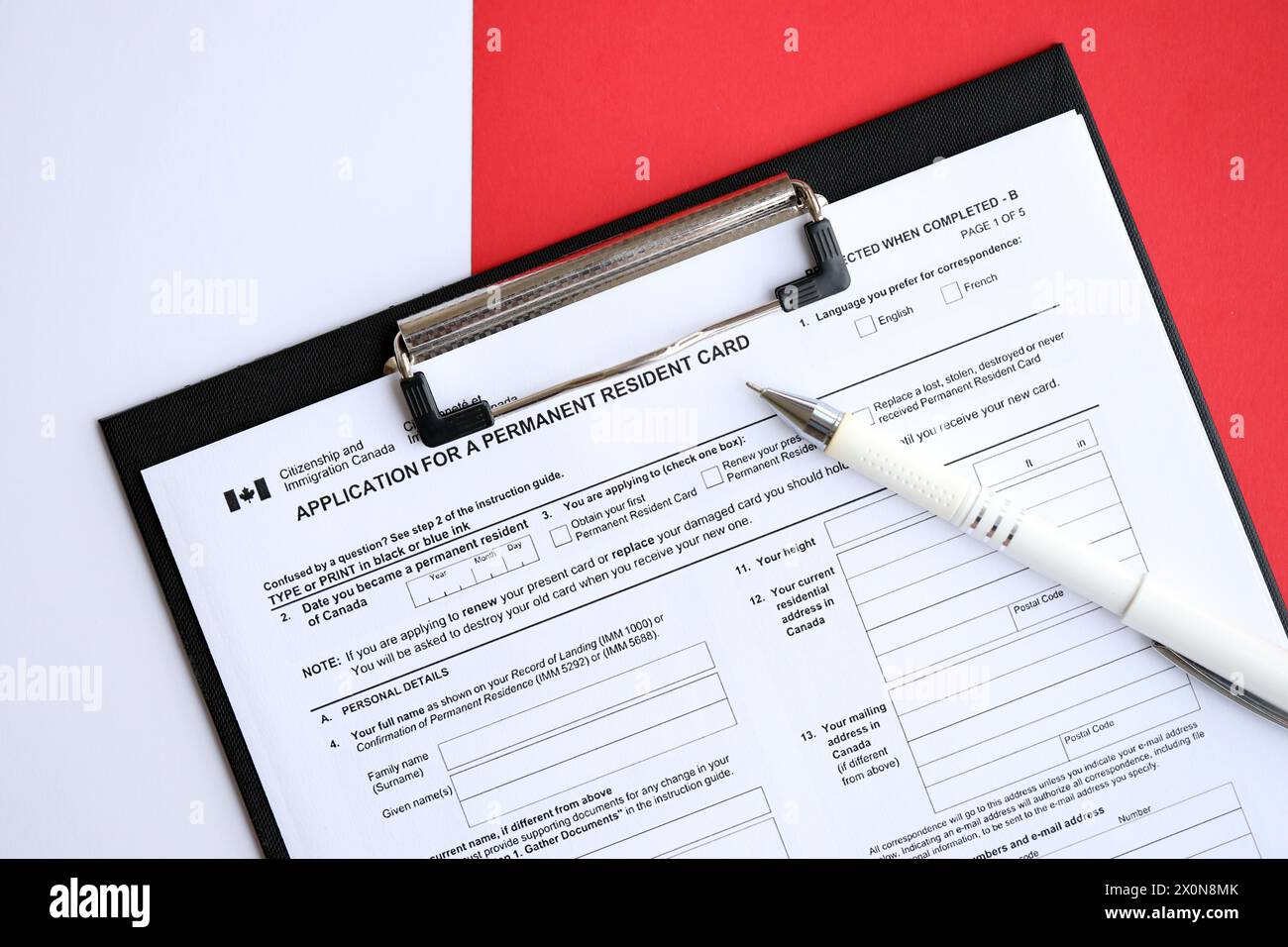 Application for permanent resident card on table with pen close up ...