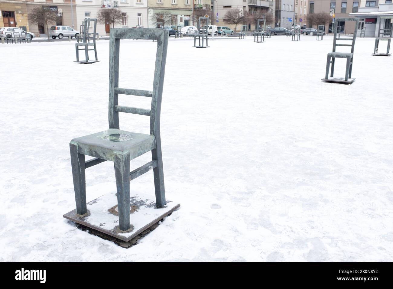 Empty chairs memorial in the snow on Jewish Heroes Square in Krakow ...
