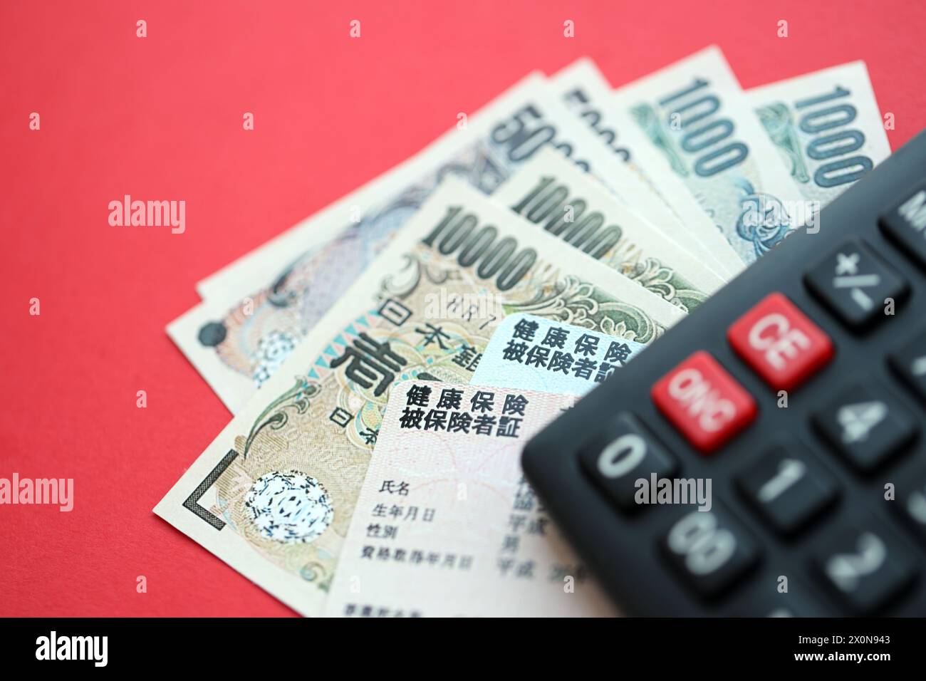 Light blue and red Japan Health Insurance cards on table with japanese ...