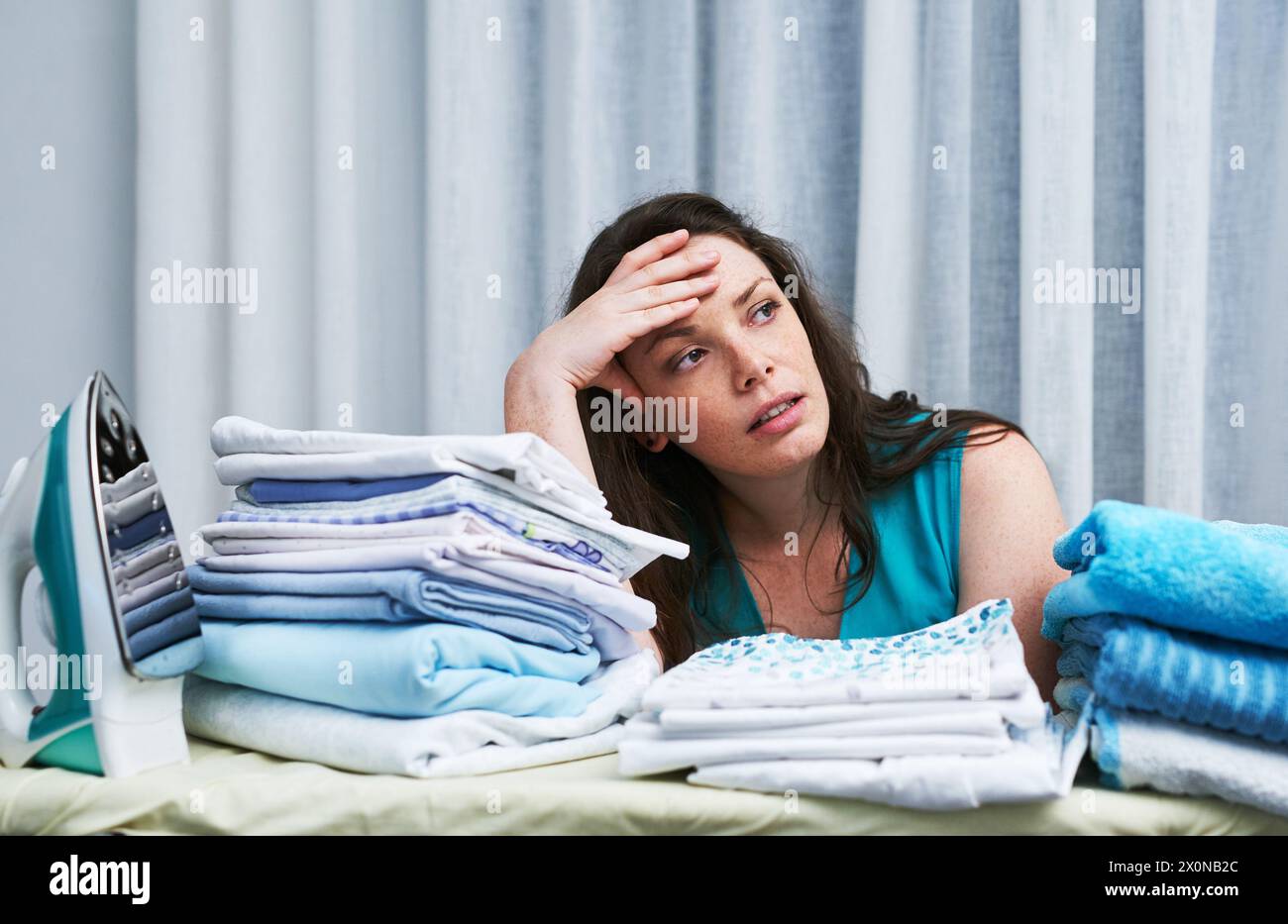 Laundry, stress headache and woman in home with mess, clothes and ...