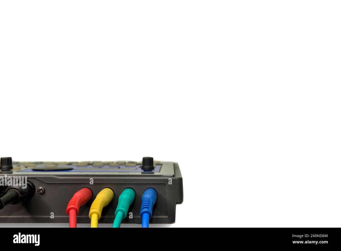 Multicolored audio jack plugs connected to a music device on a white ...