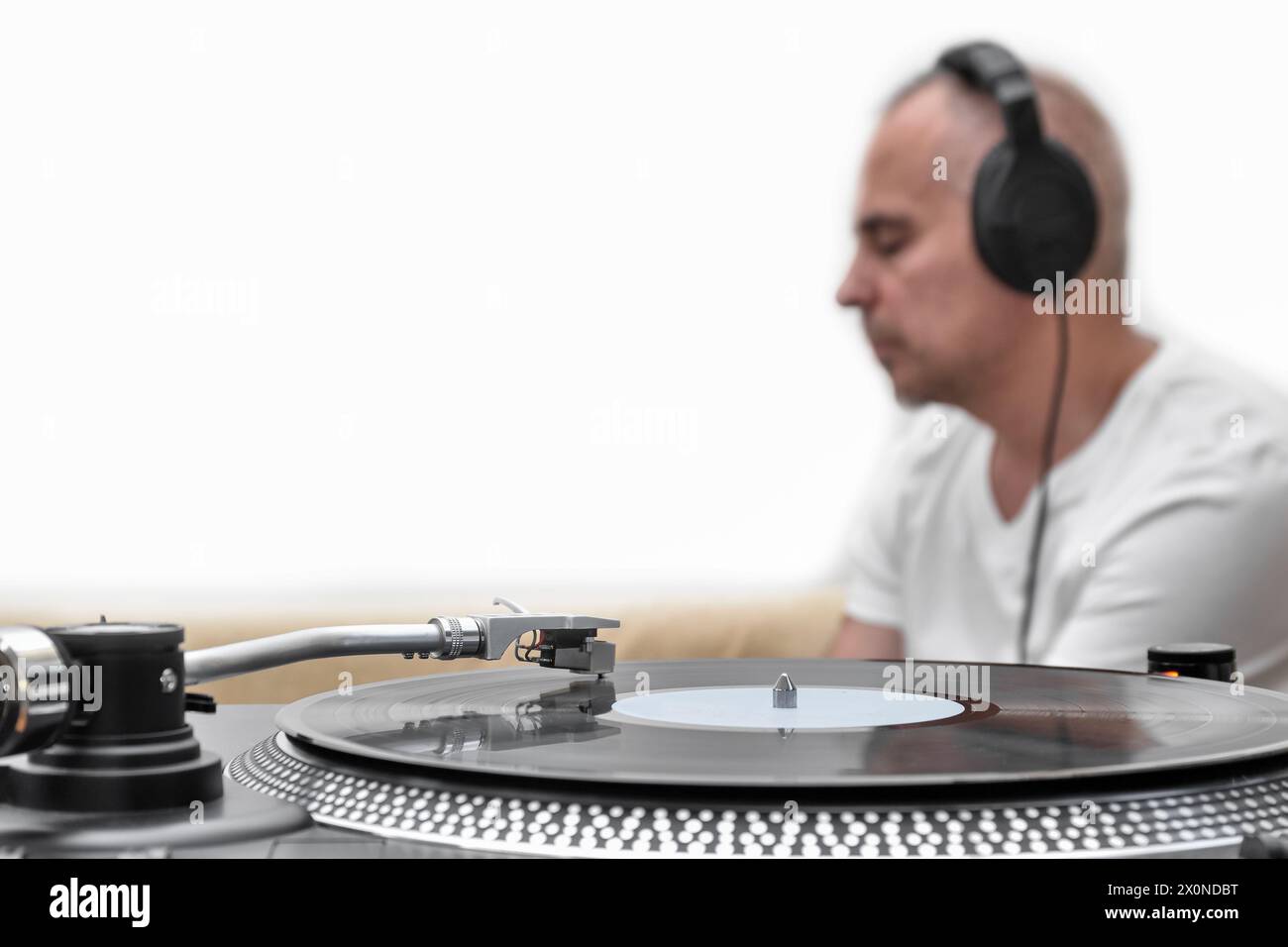 Vinyl player, turntable on the background of a blurred man in ...