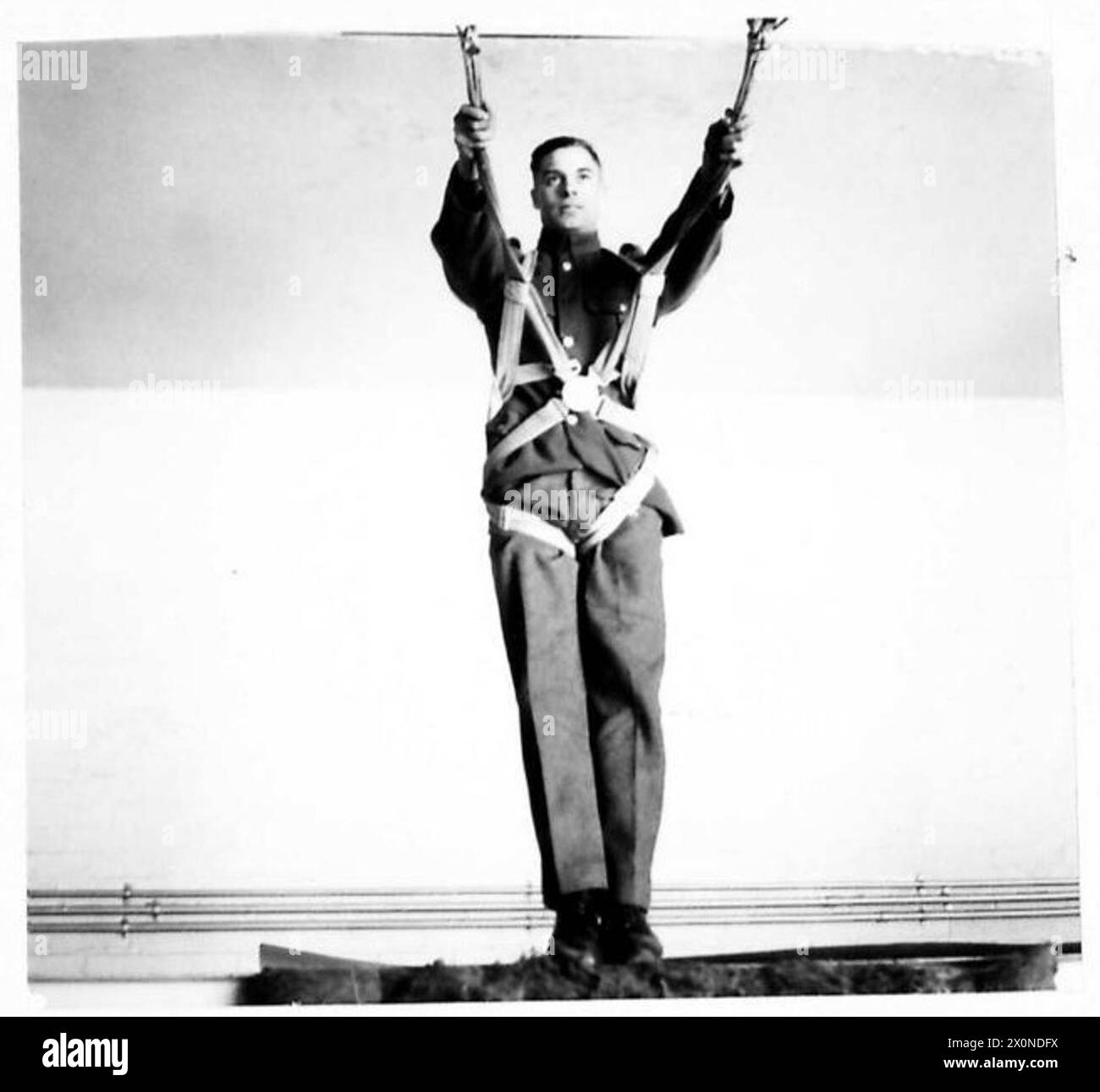 A recruit begins an initial parachute training exercise by swinging off ...