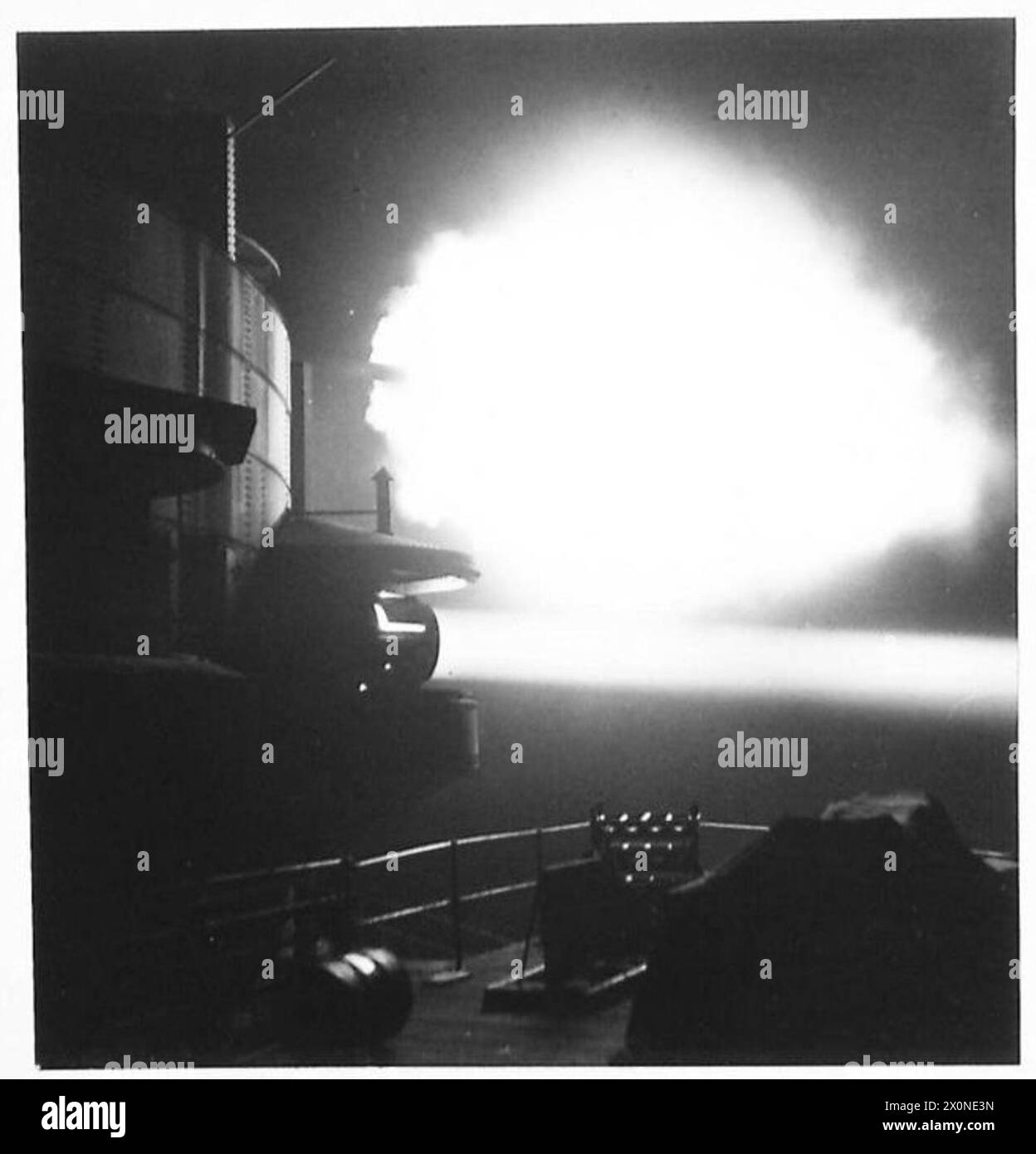 British Army coastal artillery conducts a night shoot from a sea ...