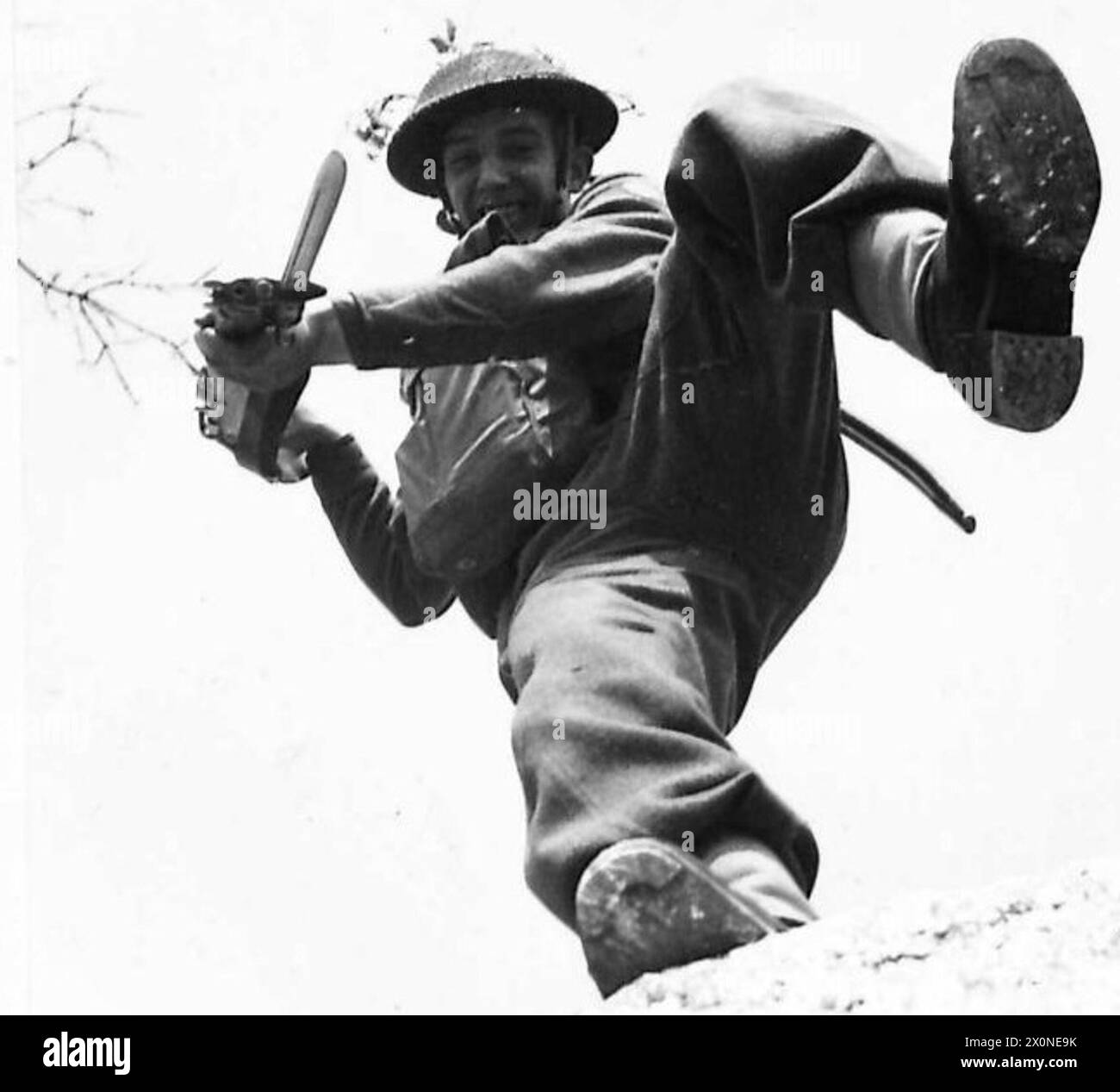 An infantryman lunges from the parapet of a trench during offensive ...