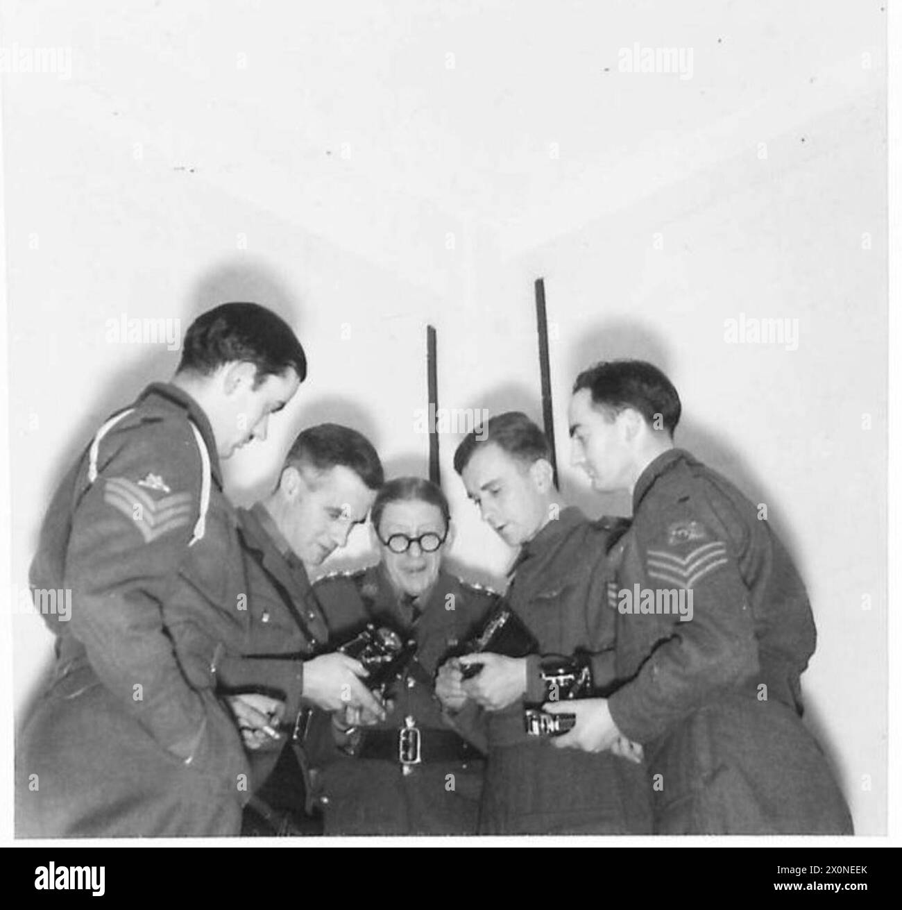 Non-commissioned officer (NCO) cameramen inspect new camera equipment ...