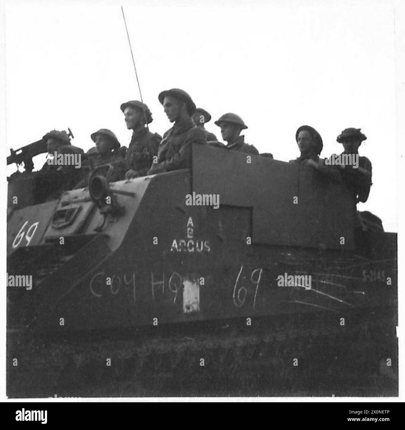 PREPARING FOR THE ATTACK SOUTH OF CAEN - Troops aboard tanks moving off ...