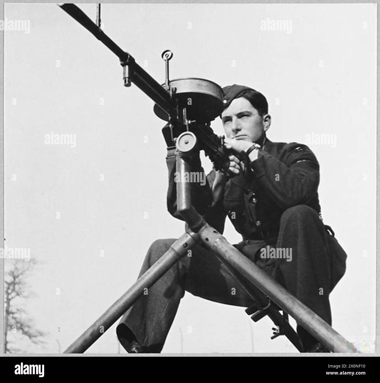 Photograph shows a pupil operating the Vickers 'K' gun on the range ...
