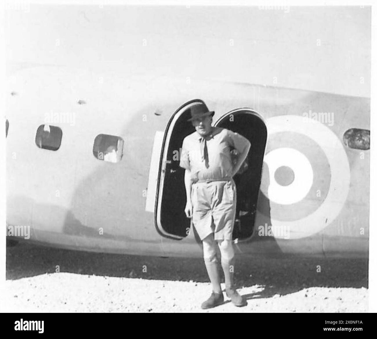 Photograph shows the Hon. Lyttelton standing by the plane used during ...