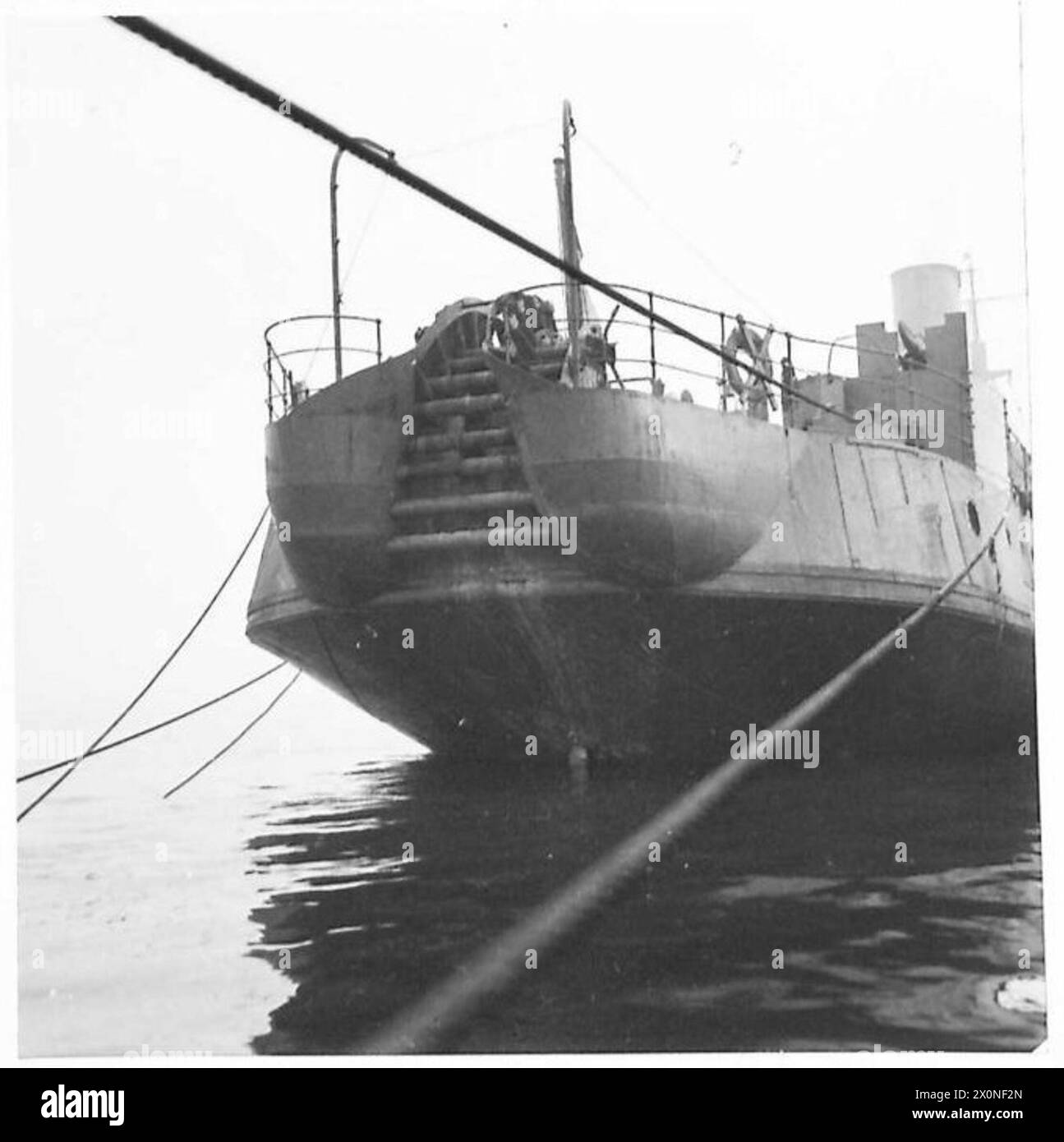 The stern rollers of a cable-laying ship are shown from the outboard ...