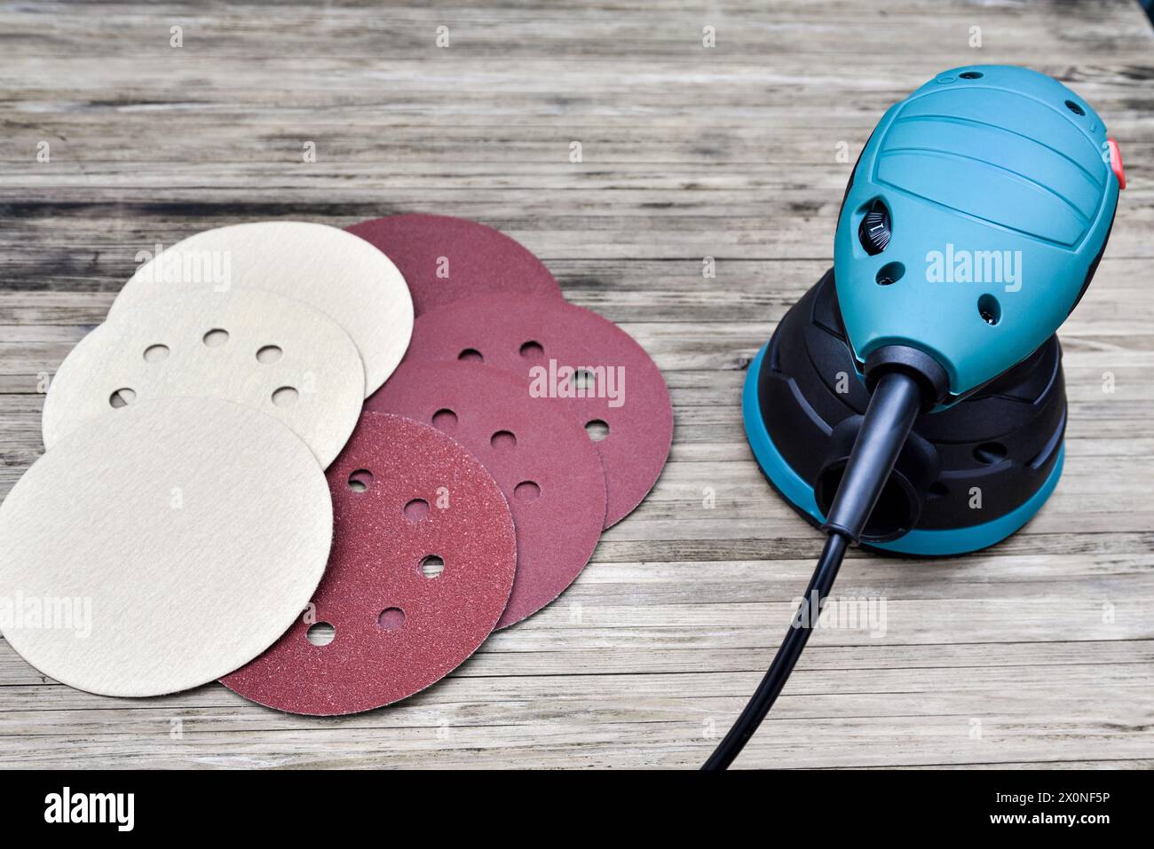 Electric portable disc grinder and round sandpaper. Random orbital ...