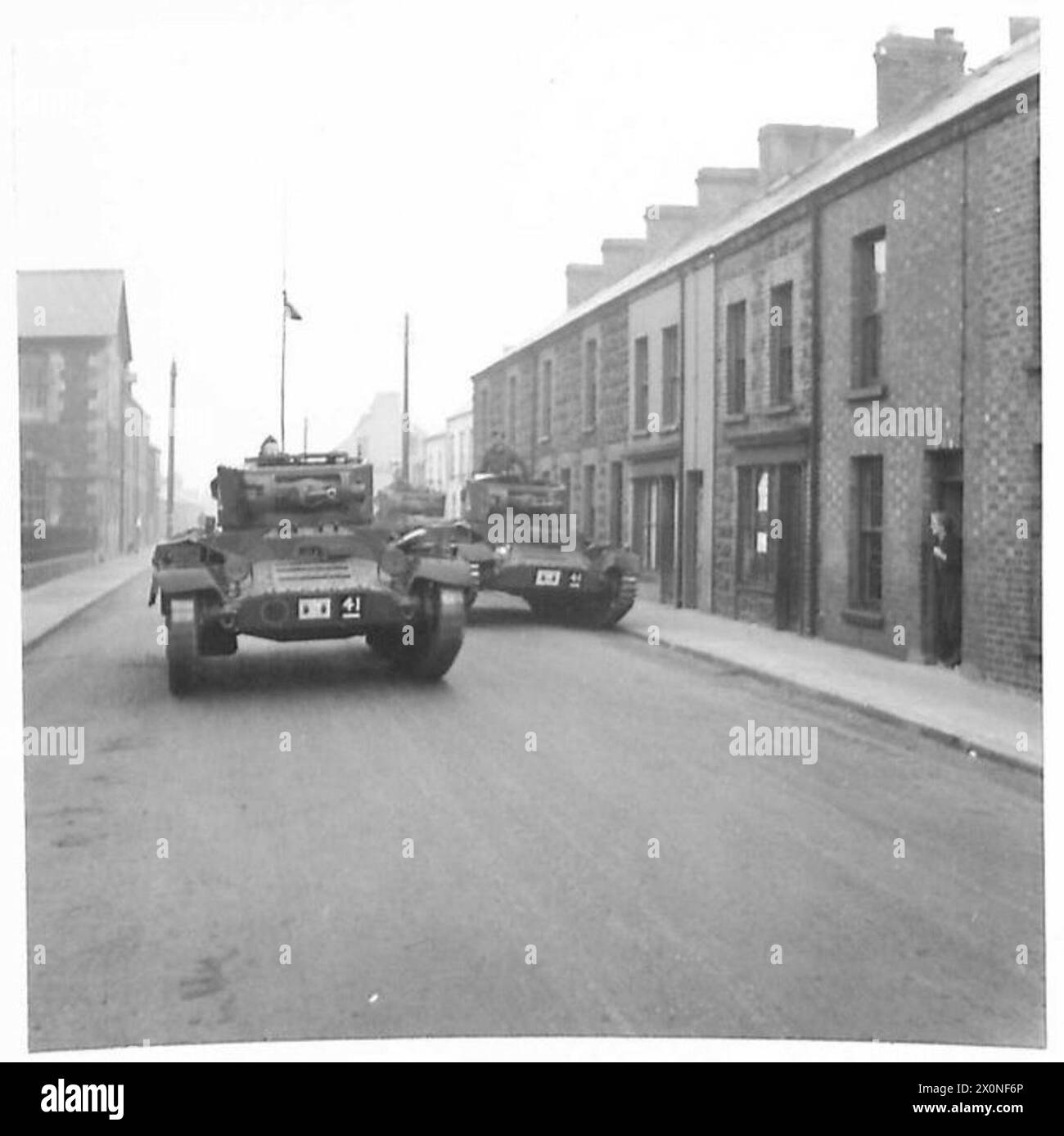Valentine tanks of the British Army move through an Ulster town as part ...