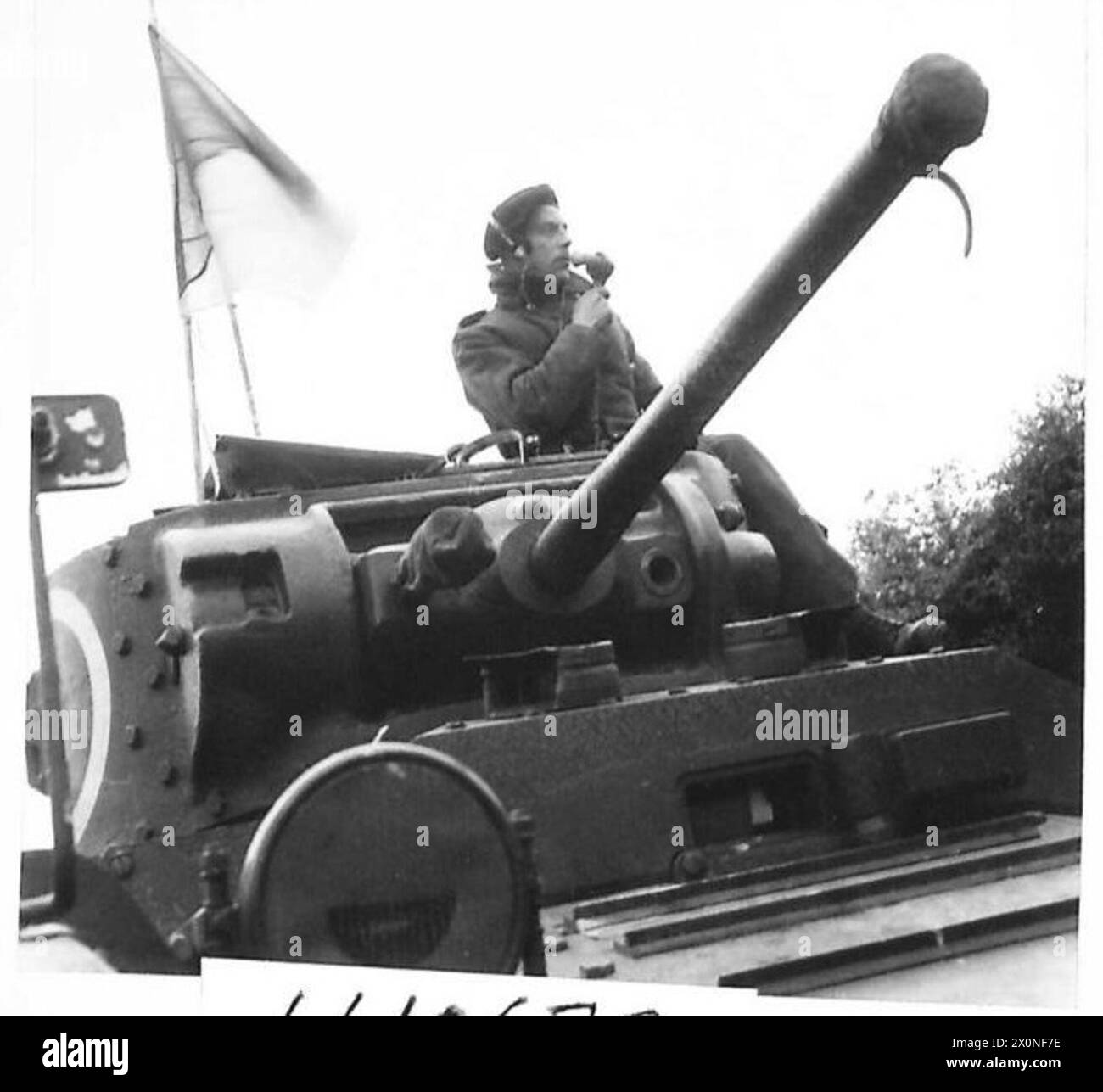 MOCK INVASION - A wireless operator on a British tank communicating ...