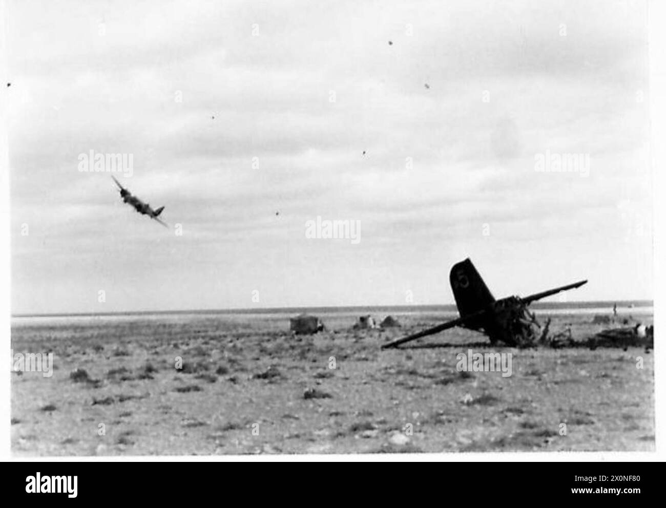 Lieut. General Ritchie's aircraft is photographed passing over a ...