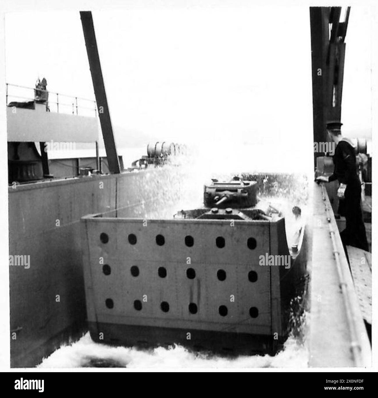Prime Minister Winston Churchill observes a landing craft launching a ...