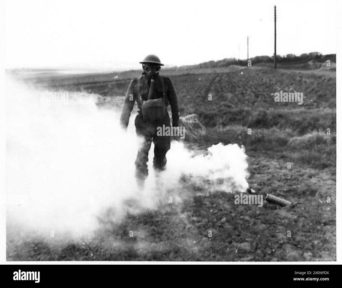 IN BONNIE SCOTLAND - A soldier tests his gas mask in a smoke screen ...