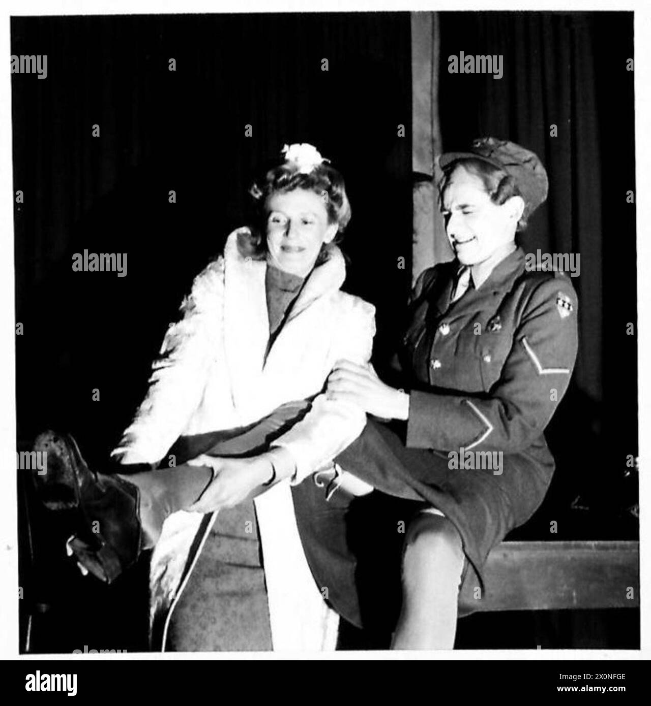 Miss E. Emms as Cinderella fits a shoe on Sub-Conductor T. McCombie ...