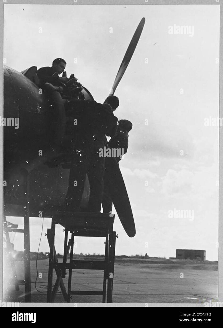 WITH A WHITLEY SQUADRON OF THE BOMBER COMMAND - Mechanics overhaul one of the Armstrong Siddeley ...