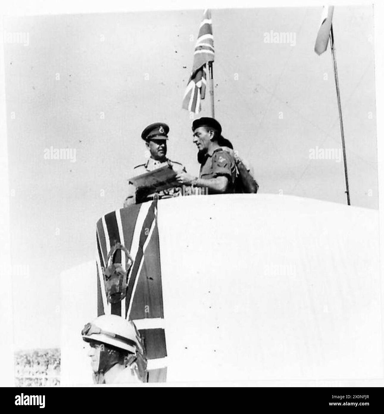 Field Marshal Harold Alexander examines the parade program for the 2nd ...