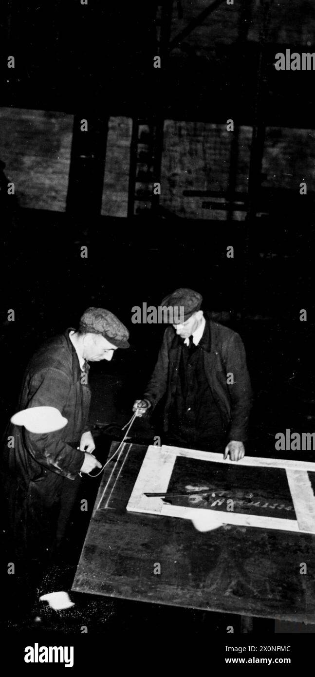 Shipyard workers in Liverpool mark off a bulkhead plate at Grayson ...