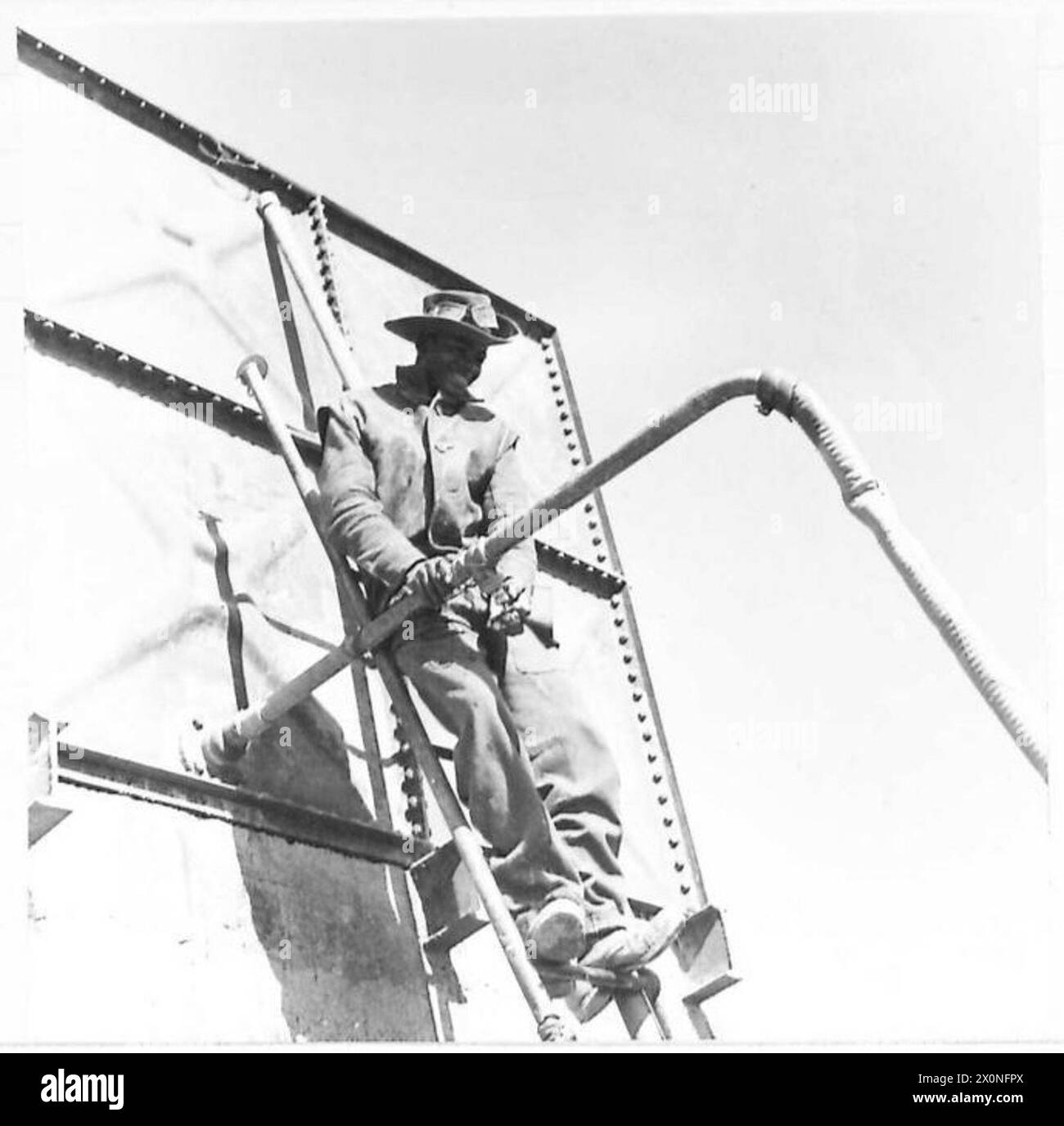 A native soldier stands on duty at the Tmimi water point in the Western Desert during British ...