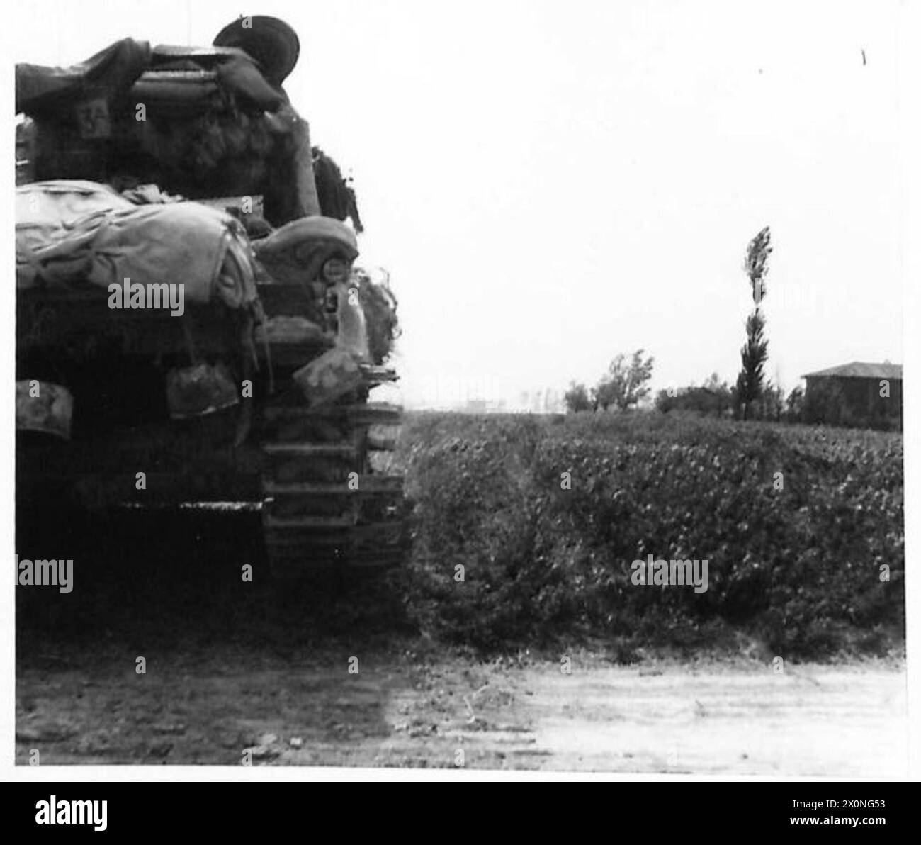 A Sherman tank of the 16/5 Lancers shells a farmhouse occupied by ...