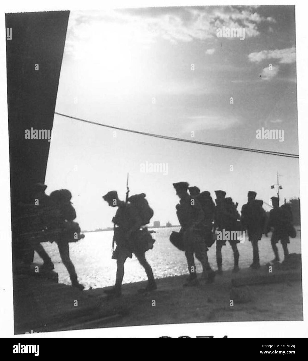 INVASION PREPARATIONS AT TRIPOLI - Troops going aboard during the early ...