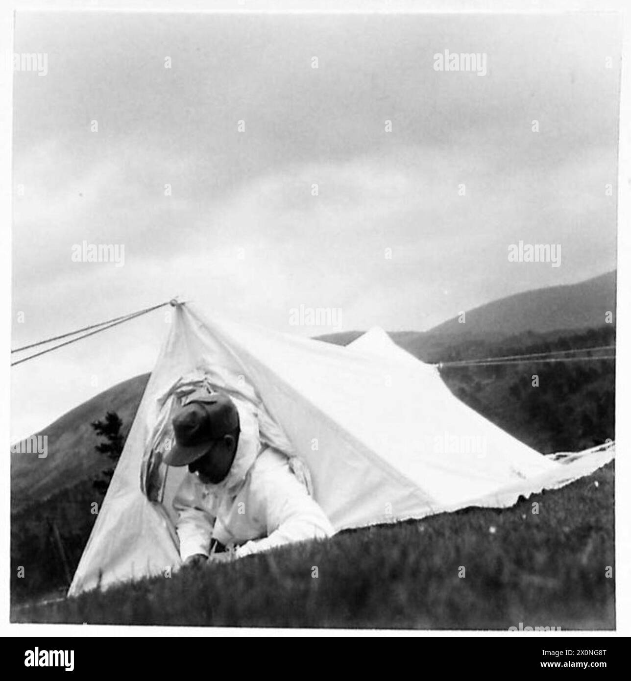 A trooper sets up a two-man tent during mountain and snow warfare ...